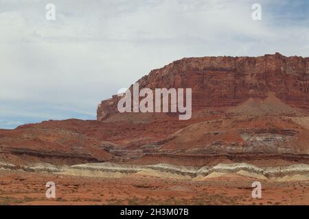 Mesa among rugged layered red rock dramatic desert landscape at the ...