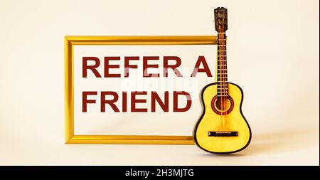 Refer a friend text on white notepad Stock Photo - Alamy