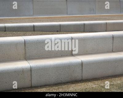Modern angled outdoor steps with rounded corners in textured grey and ...