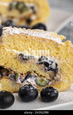 Blueberry roulade with icing sugar Stock Photo - Alamy