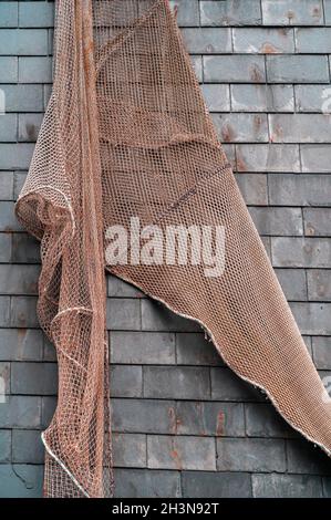 Fishing net drying on the wall of a house in Honfleur in french ...