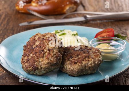 Two meatballs on a plate with mustard and ketchup Stock Photo - Alamy