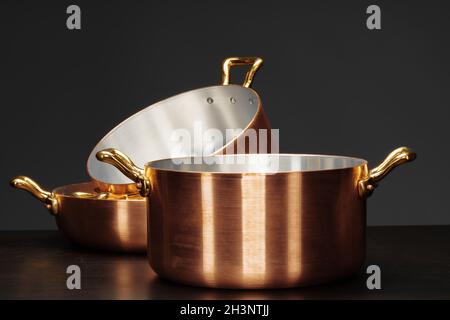Set of copper cookware over dark background Stock Photo - Alamy