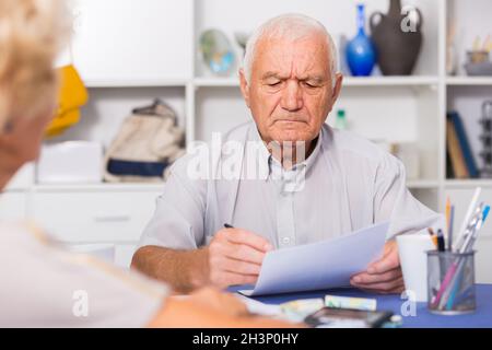 Upset senior man discussing with wife bills Stock Photo - Alamy