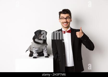 Animals, party and celebration concept. Handsome young man in suit and ...