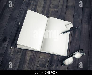 Open book, glasses, pencil, eraser and cactus on wooden background ...