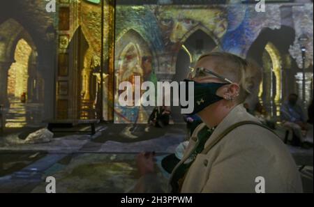 A museum-goer watches the projection mapping during the show. Van Gogh ...