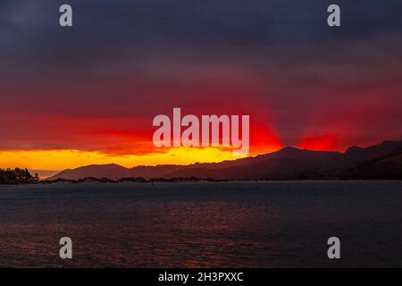 Sunset over Pilot Bay in New Zealand Stock Photo - Alamy