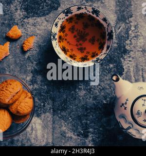 Calm China tea set with yummy biscuits on the blue table. Relaxing time ...