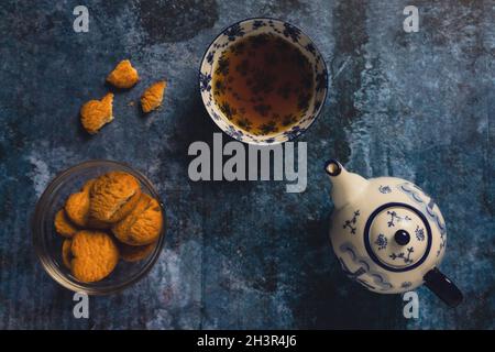 Calm China tea set with yummy biscuits on the blue table. Relaxing time ...