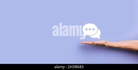 Businessman holding a message icon, bubble talk notification sign in ...