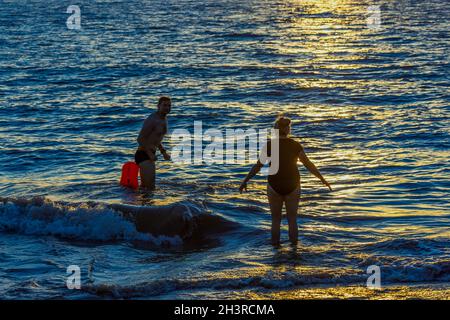 Going in for a dip off Clevedon beach Stock Photo - Alamy