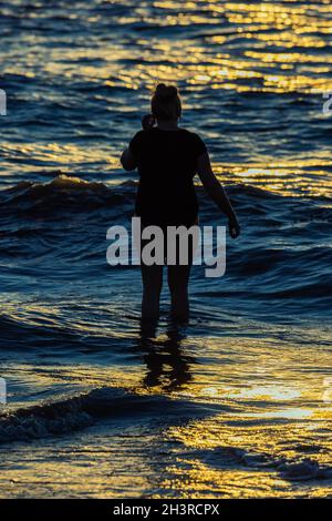 Going in for a dip off Clevedon beach Stock Photo - Alamy