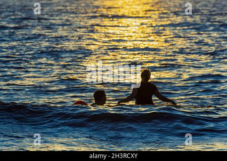 Going in for a dip off Clevedon beach Stock Photo - Alamy