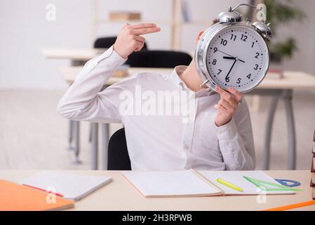 Schoolboy in time management concept in the classroom Stock Photo - Alamy