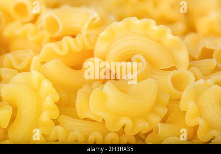 Dry curly pasta close-up. Pasta made of durum wheat top view. Yellow ...