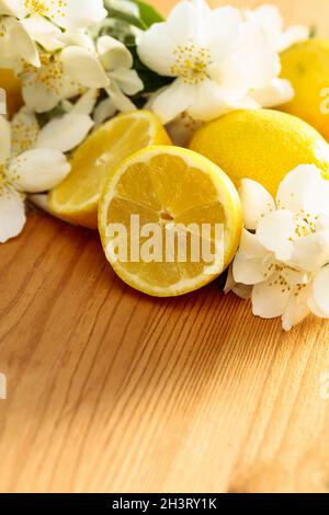 Flowering jasmine and lemons on a wooden background. Ingredients for ...