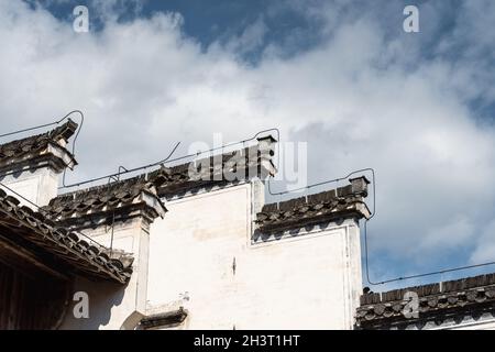 A Chinese Hui Style house with black roof tiles, white wall, and ...