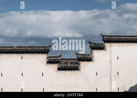 A Chinese Hui Style house with black roof tiles, white wall, and ...