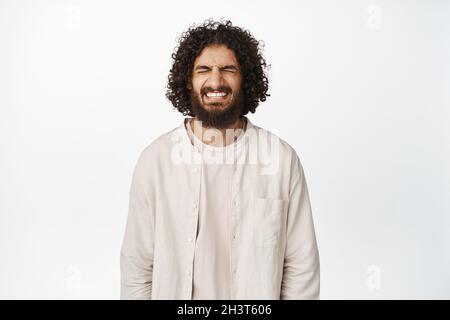 Image of gloomy and sad handsome male model in black suit, frowning and ...