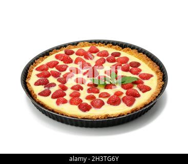 baked round tart with strawberries and tender milk cream on a white ...