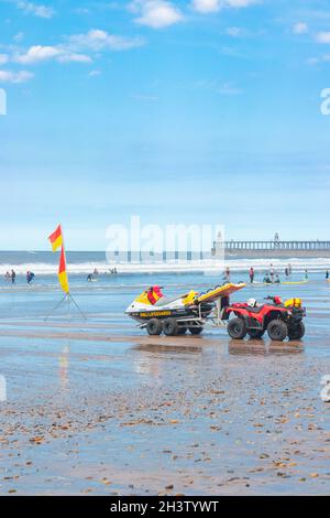 RNLI lifeguard ATV with rescue power boat jet ski on trailer on beach ...