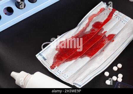 Stained medical protective mask with test tubes. Coronavirus diagnostic ...