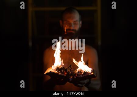 Man hold burning book in his hands Stock Photo - Alamy