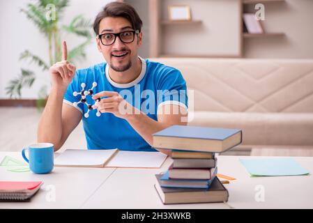 Young student physicist studying molecular model at home Stock Photo ...