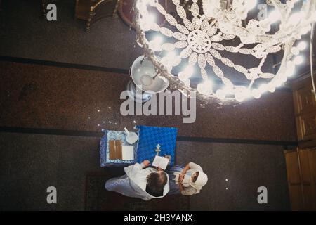 Orthodox Christian priest and parishioner praying in the church Stock ...