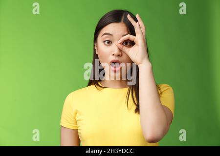 Impressed asian girl drop jaw shocked look camera surprised pointing ...
