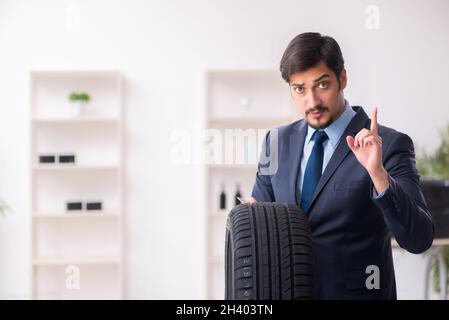 Young businessman selling tires in the office Stock Photo - Alamy