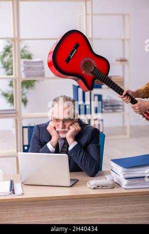 Old employee unhappy with excessive work in the office Stock Photo - Alamy