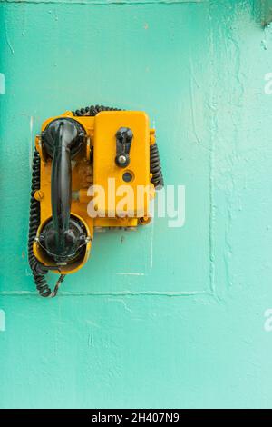 Old telephone on yellow background with copy-space Stock Photo - Alamy