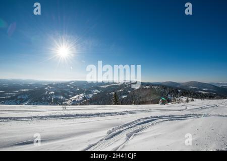 ATV and ski tracks in snow on frosty winter day Stock Photo - Alamy