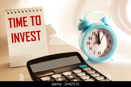 Time To Invest text on notepad with alarm clock on wooden background ...