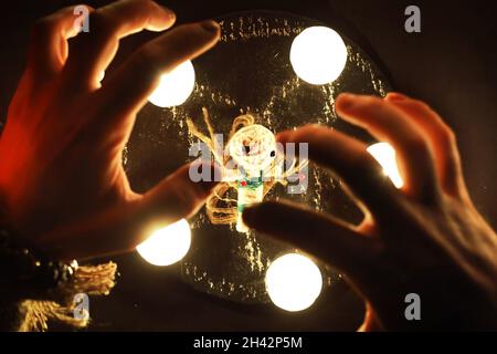 Mystic still life with voodoo doll, the tarot cards, books, evil candles and witchcraft objects ...