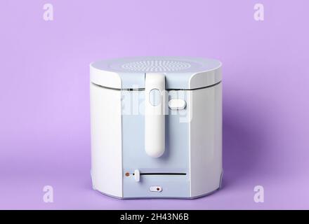 Modern deep fryer on color background Stock Photo - Alamy