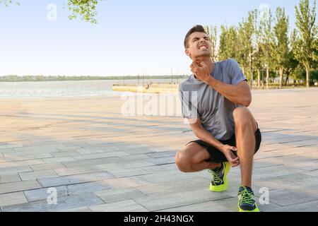 Young man scratching himself outdoors Stock Photo - Alamy