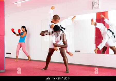 Men perform strength techniques and grabs at self-defense training in ...