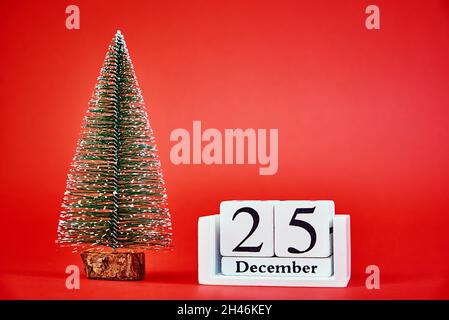 25 december. Christmas composition on colored background with a wooden ...