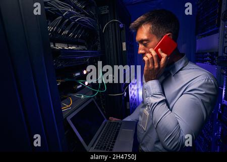 System administrator monitoring server performance in co-location ...
