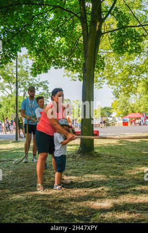 POZNAN, POLAND - Jan 27, 2018: Woman and young boy steering something ...