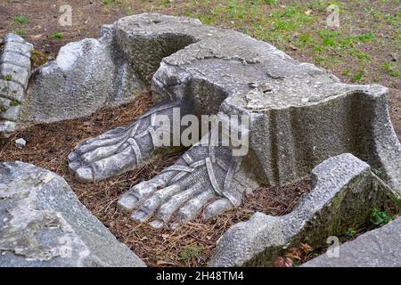 Fallen ancient Greek sculpture head fallen in front of the remains of a ...