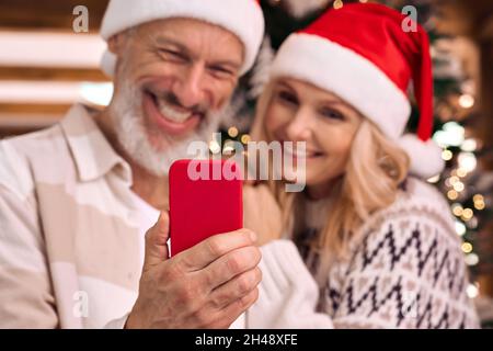 Happy family in Santa hats preparing for Christmas Stock Photo - Alamy