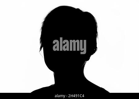 Black backlit silhouette of head and shoulders of an oriental woman ...