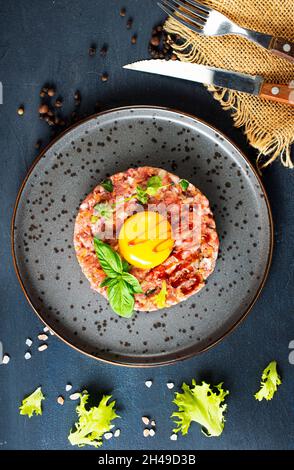 tar-tar from beef with raw yolk on plate Stock Photo - Alamy