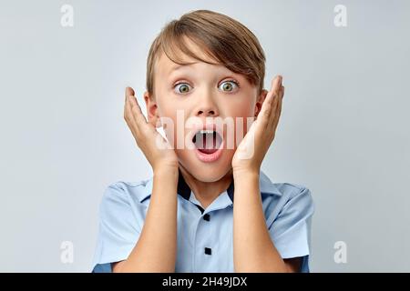 Adorable young boy in shock, isolated over white background. Shocked ...