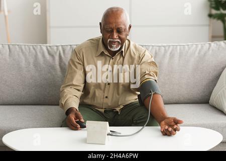 Senior African Male Measuring Arterial Blood Pressure Having ...