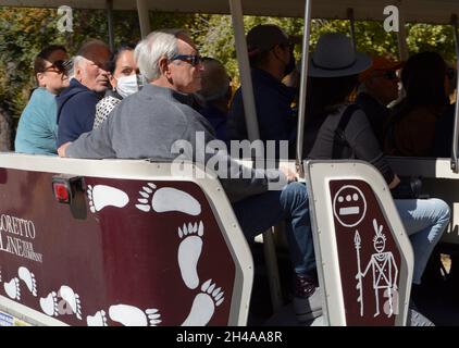 Tourists visiting Santa Fe, New Mexico, enjoy a guided bus tour of the ...